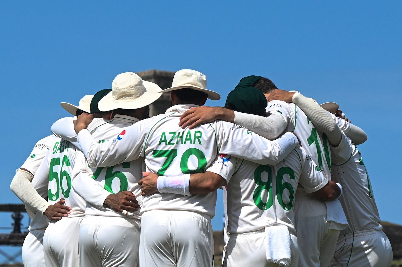 The Pakistan players get into a huddle before the start of the game ...