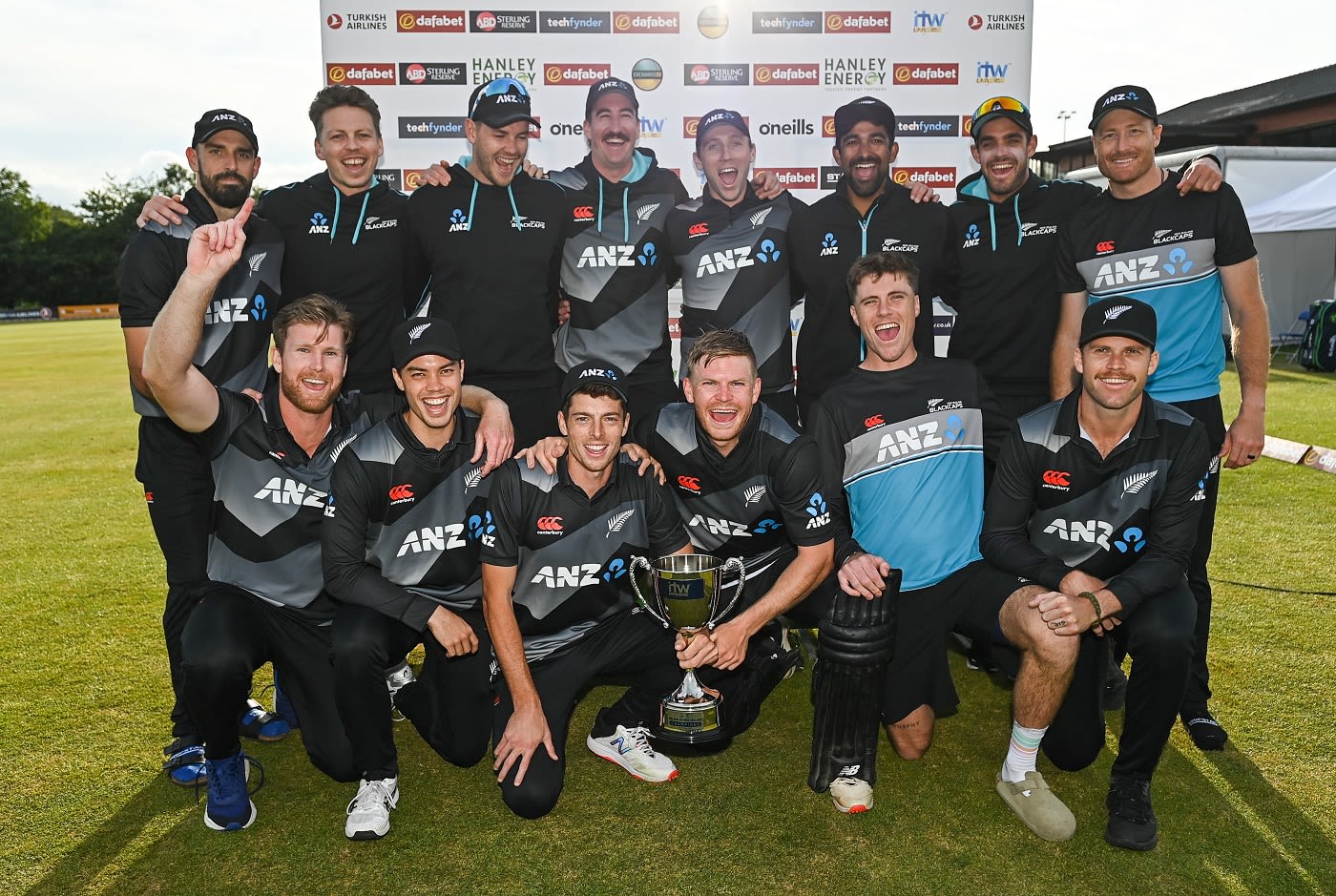 The victorious New Zealand team poses with the series trophy ...
