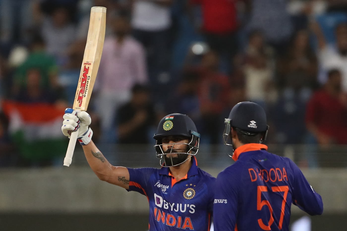 Virat Kohli raises his bat after reaching yet another fifty ...