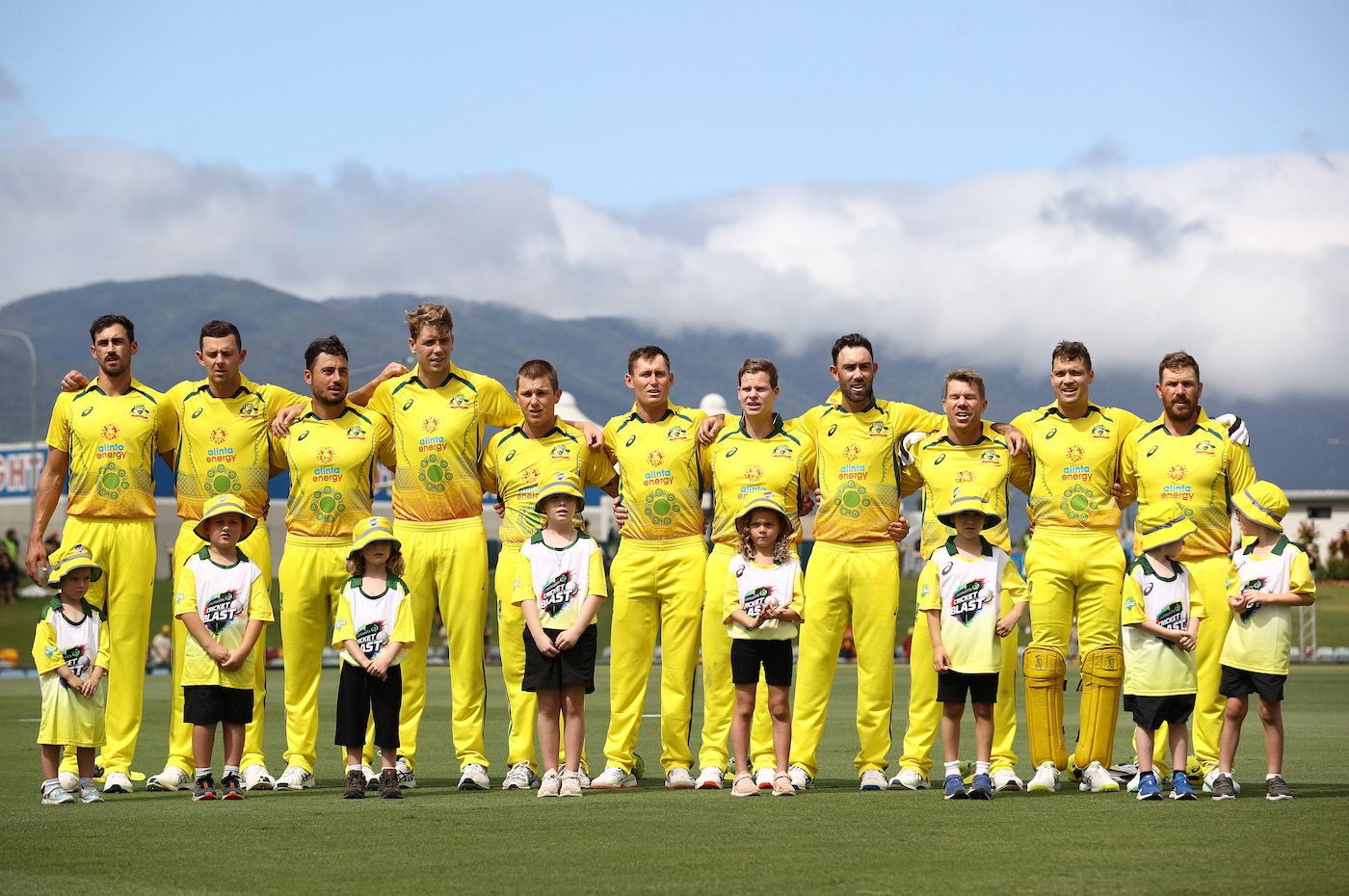 The Australian team gets together for the national anthem ...