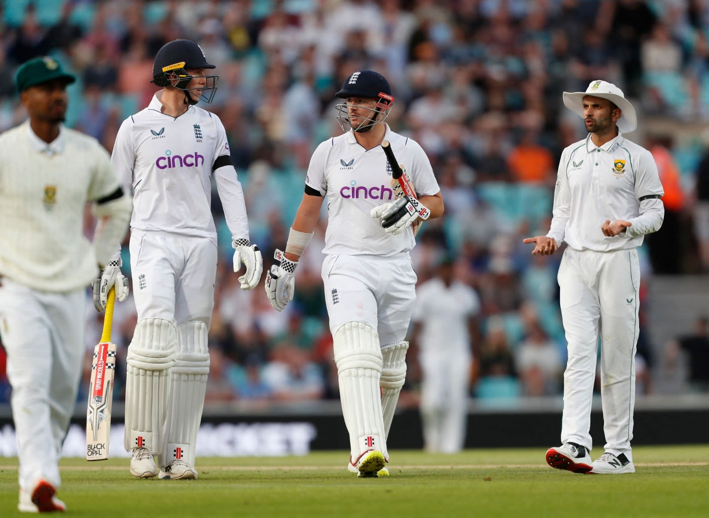Zak Crawley and Alex Lees look bemused as the players leave the field ...