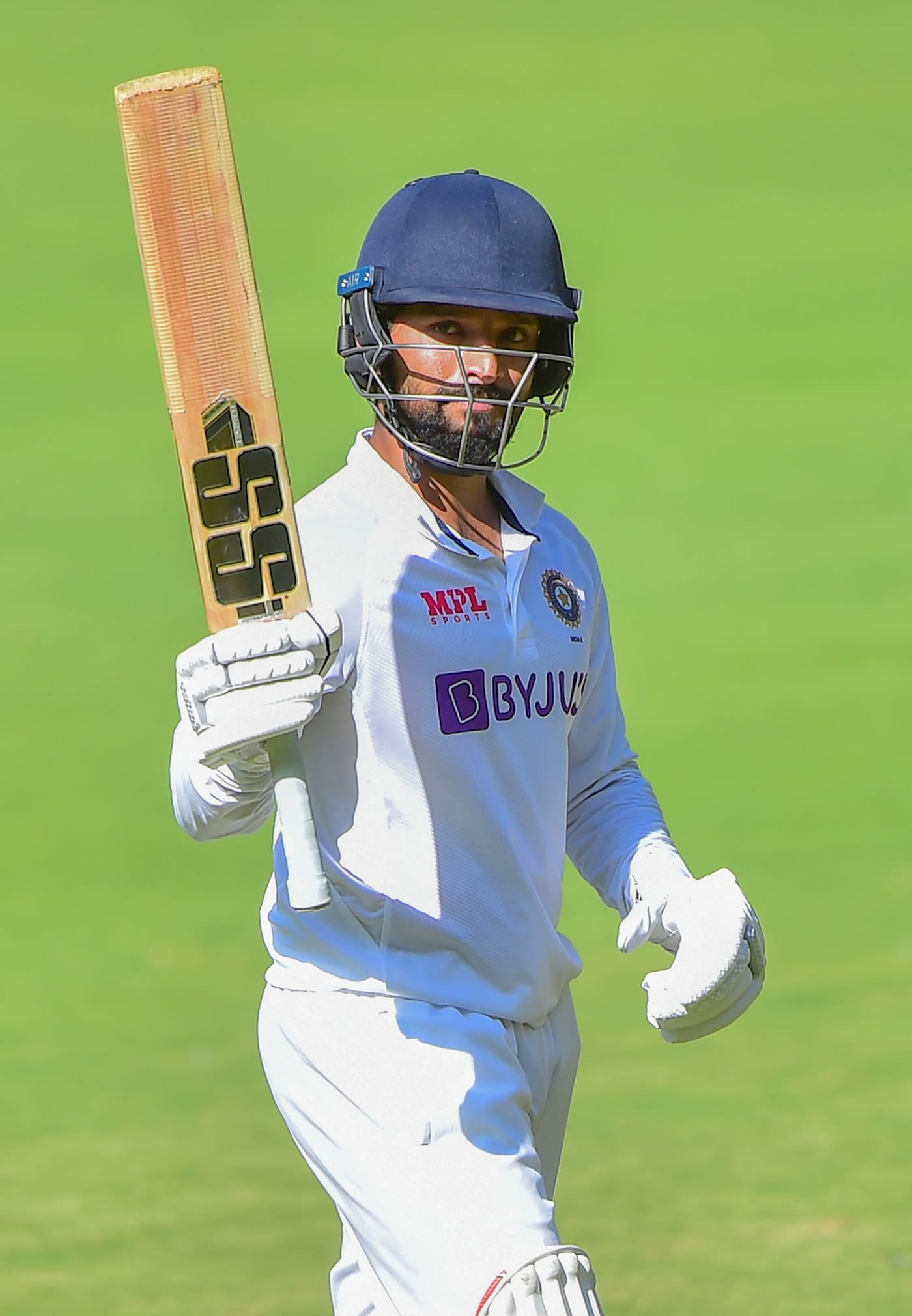 Rajat Patidar raises his bat as he walks back to the pavilion after ...