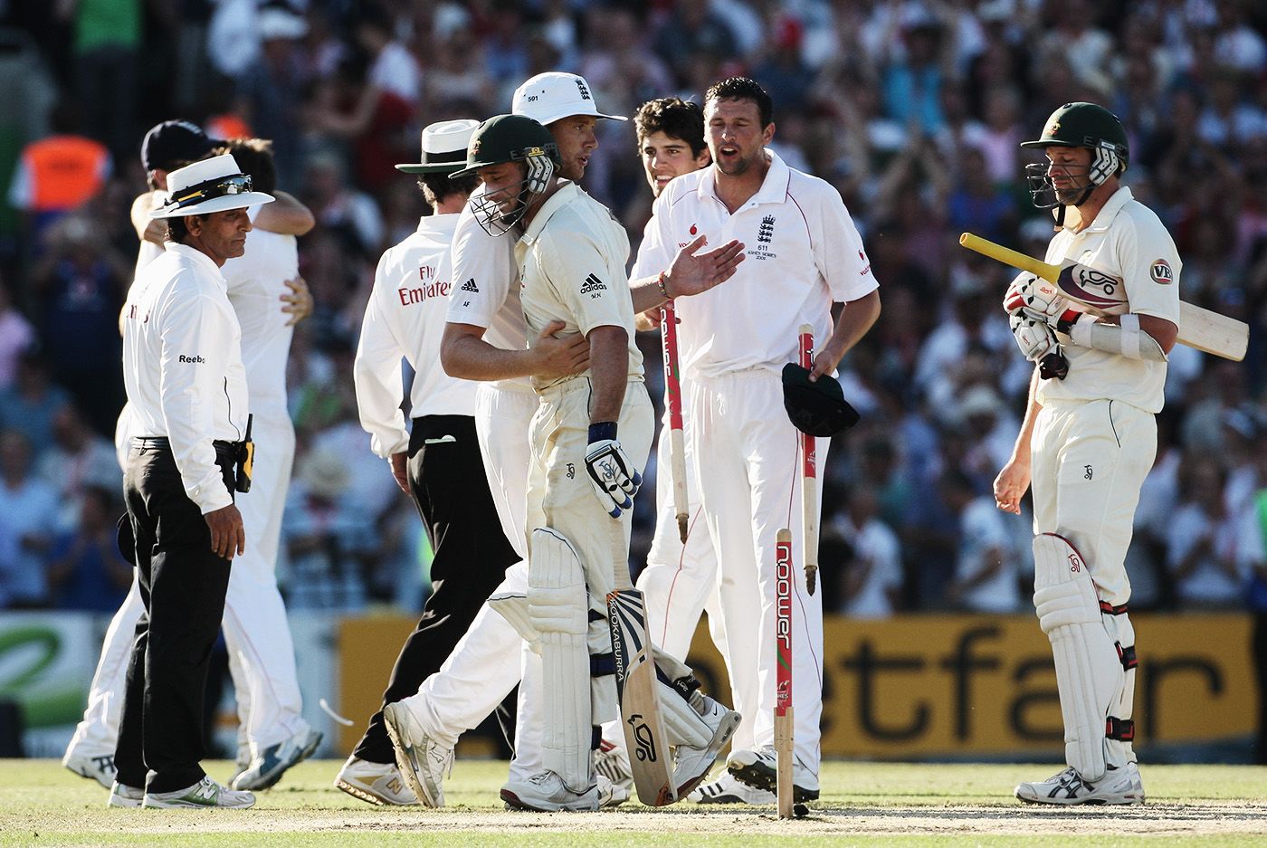 Andrew Flintoff gives Mike Hussey a hug at the end of the match ...