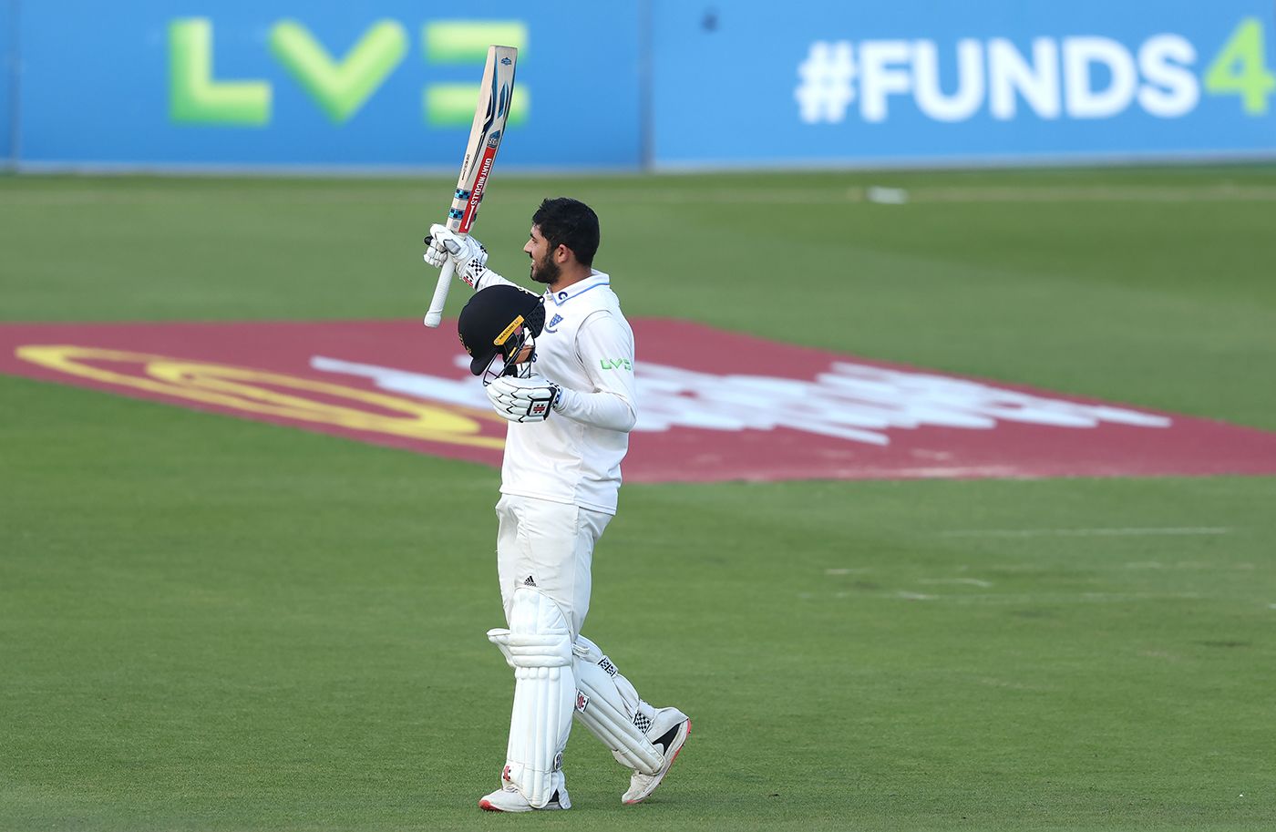 Dan Ibrahim raises his bat on reaching a maiden hundred | ESPNcricinfo.com