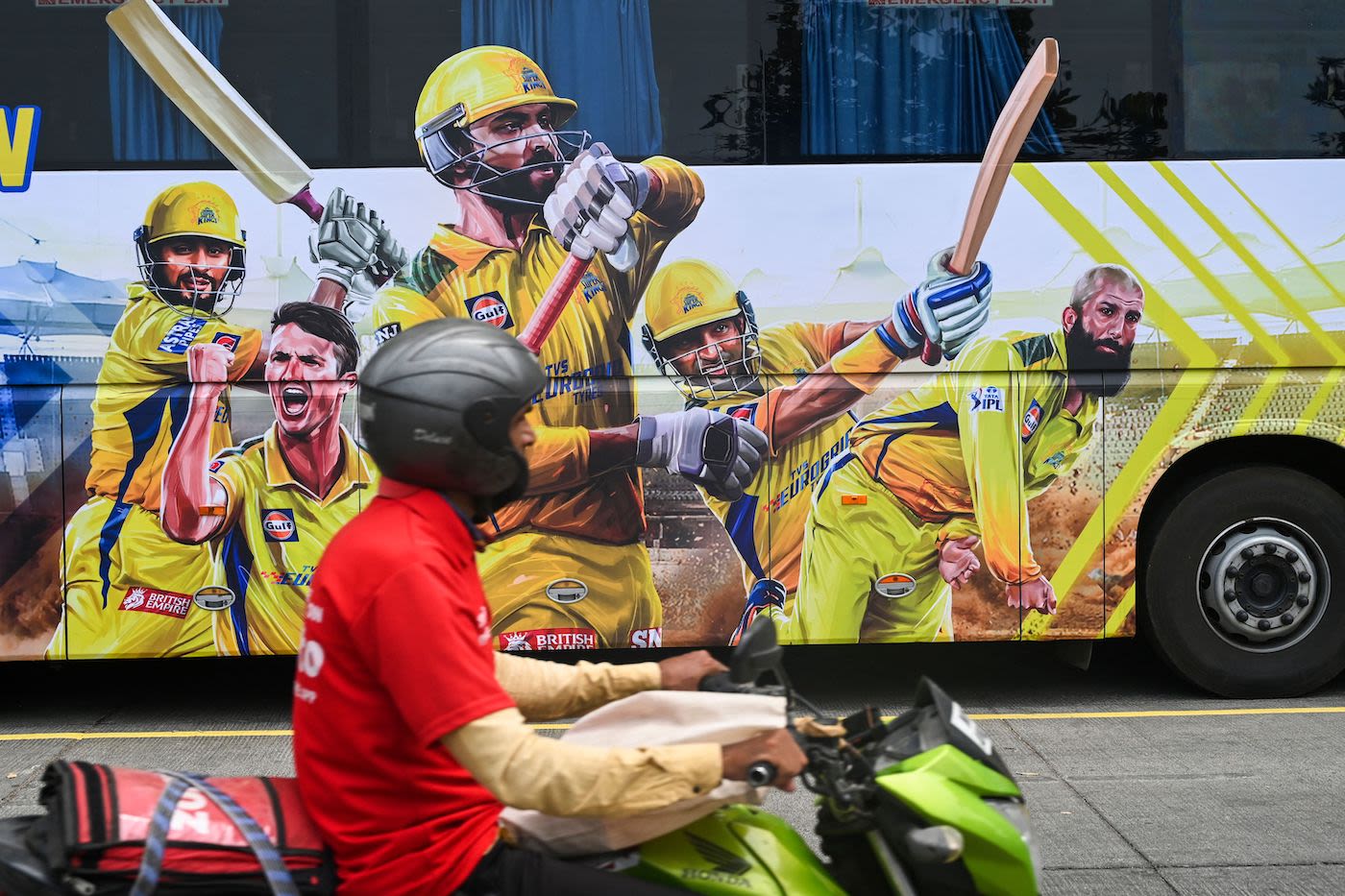 A biker drives by the Chennai Super Kings team bus | ESPNcricinfo.com