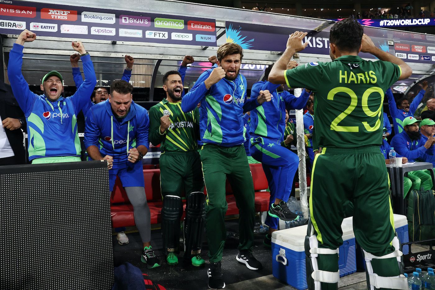 Players and staff members celebrate after Pakistan confirmed their ...