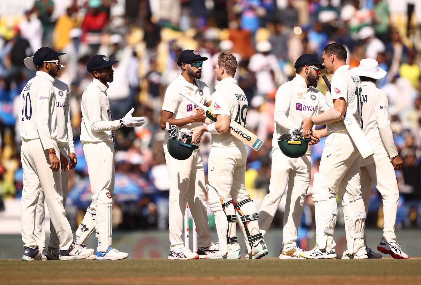 The players greet each other after India's innings victory ...