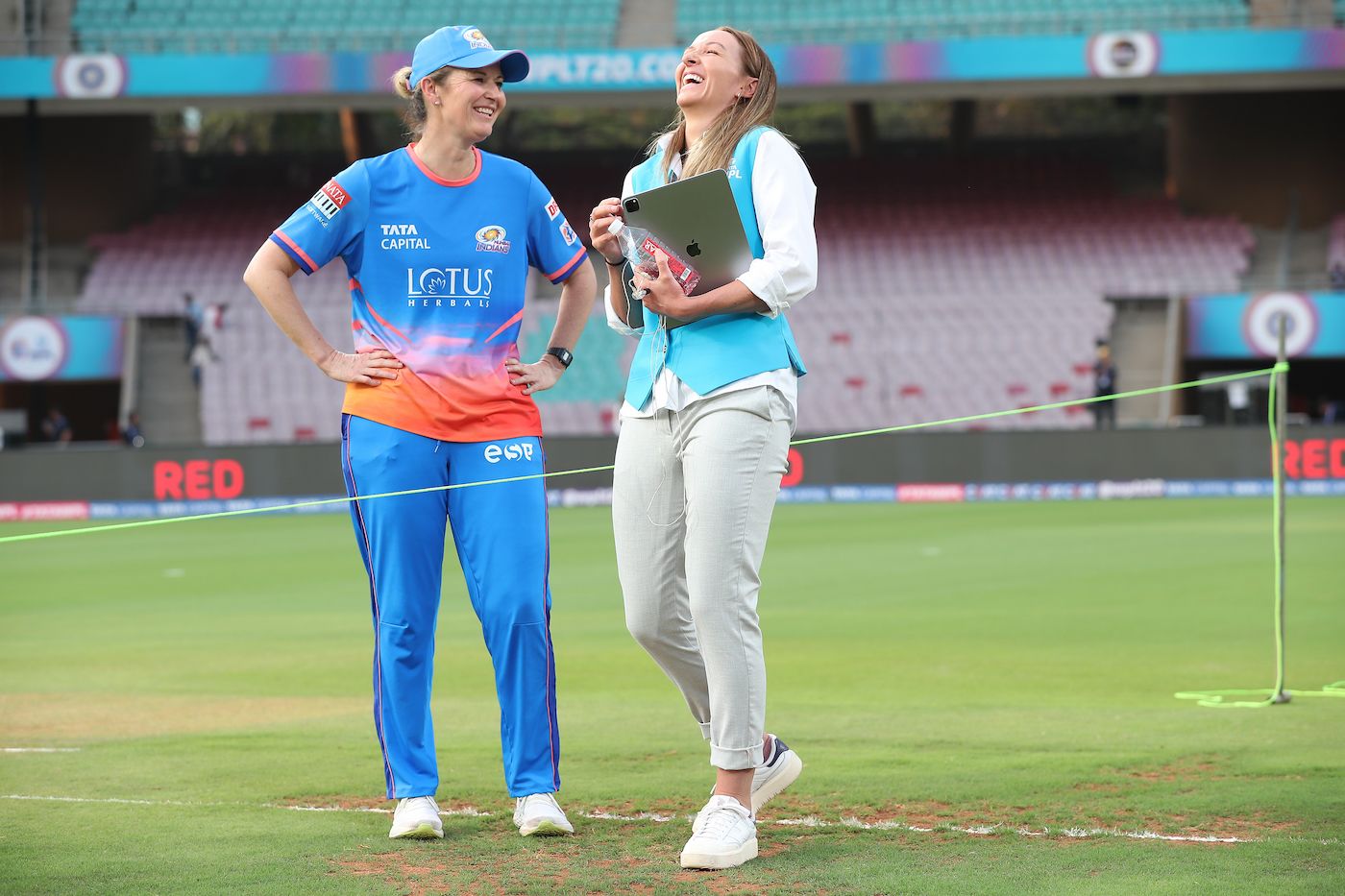 England mates Charlotte Edwards and Kate Cross catch up before the game ...