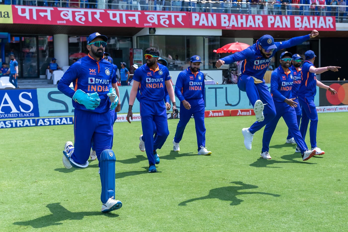 Virat Kohli takes a leap as the Indian players walk out to the field ...