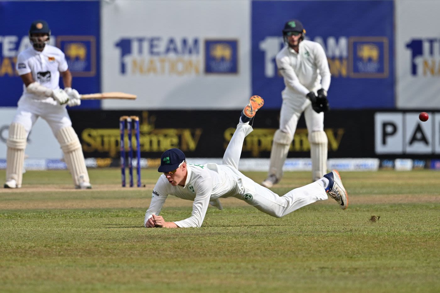 Dimuth Karunaratne and Lorcan Tucker watch the ball and Harry Tector ...