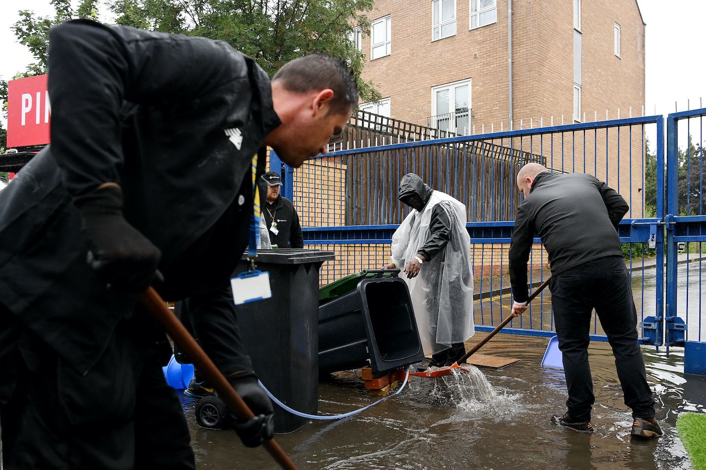 Excess rain is shoveled out into brick-elevated bins at Edgbaston ...