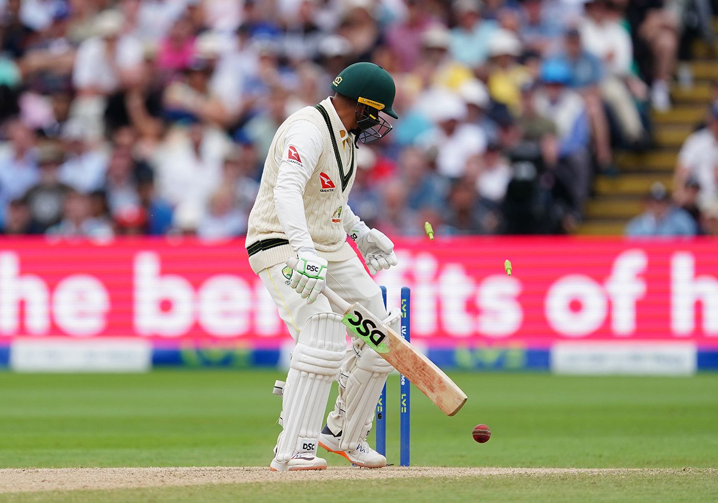 Usman Khawaja looks back as his wicket is broken | ESPNcricinfo.com