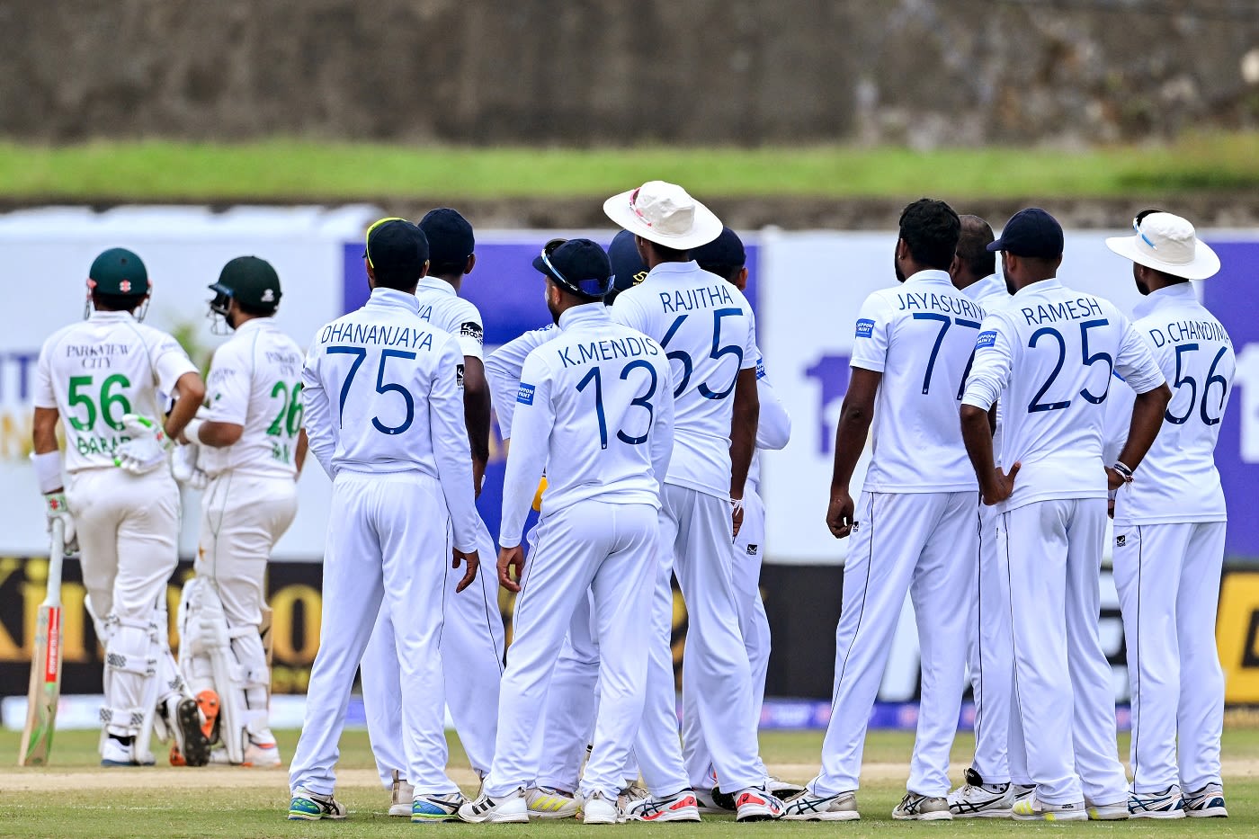 Players wait for the DRS decision after Babar Azam was trapped lbw ...