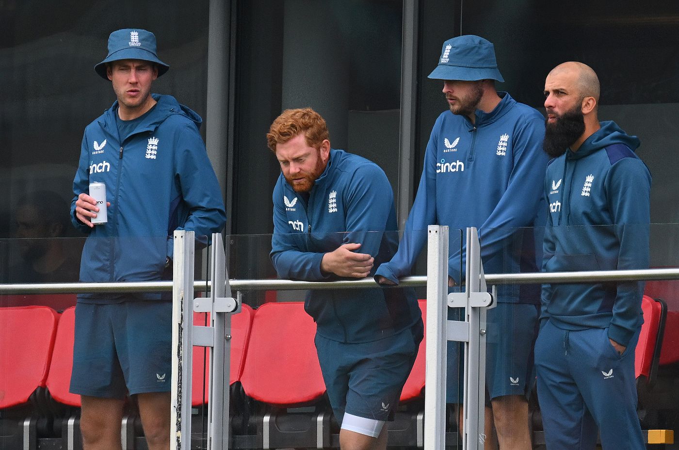 England's players look on from the balcony as the mop-up continues ...