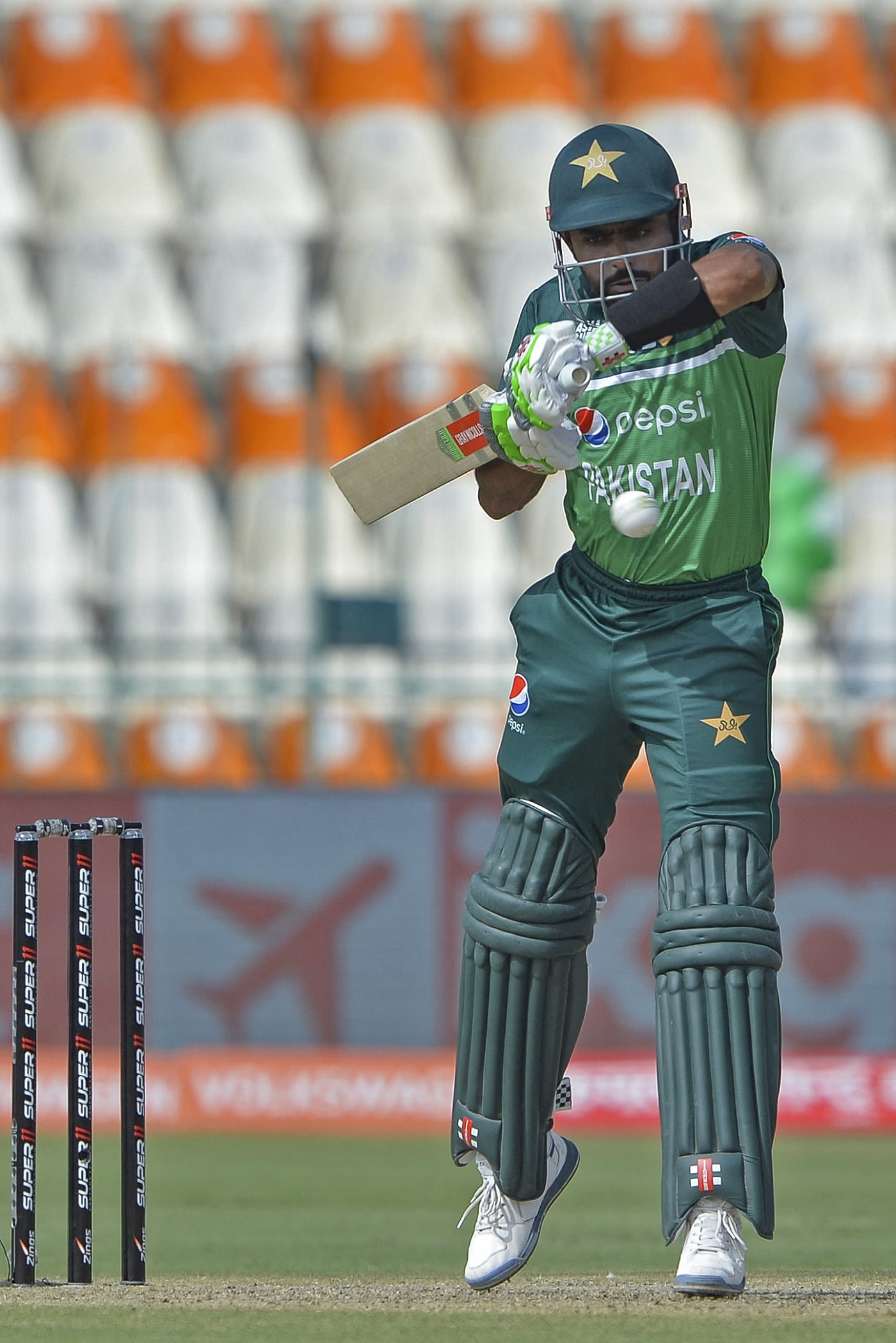 Babar Azam looks to ride the bounce while playing a short ball ...