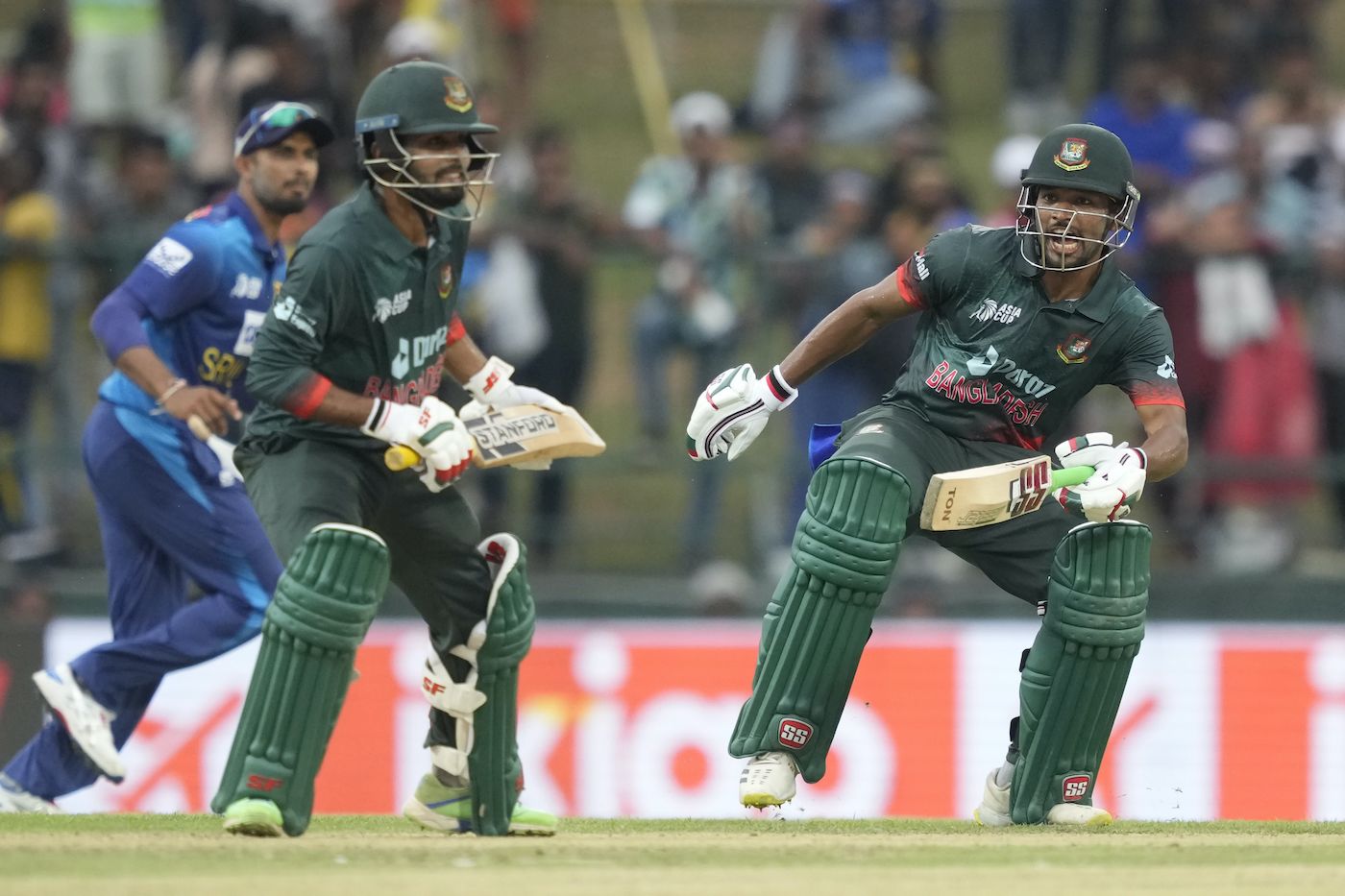 Najmul Hossain Shanto and Towhid Hridoy get caught between watching the ball and watching each ...