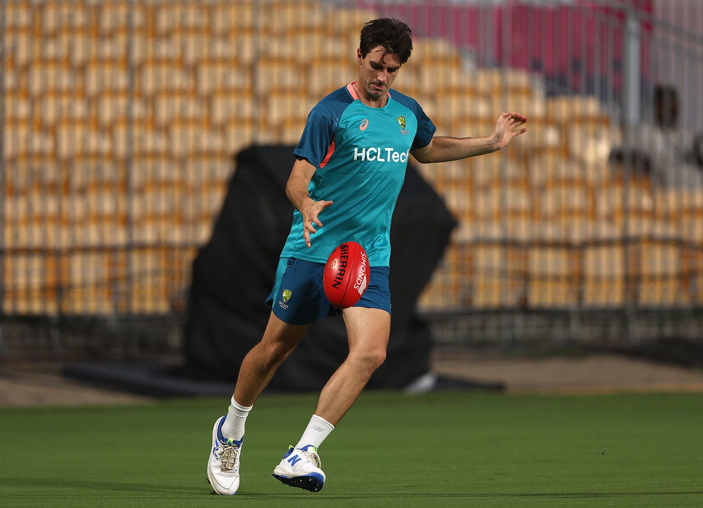 Pat Cummins kicks a football during training | ESPNcricinfo.com