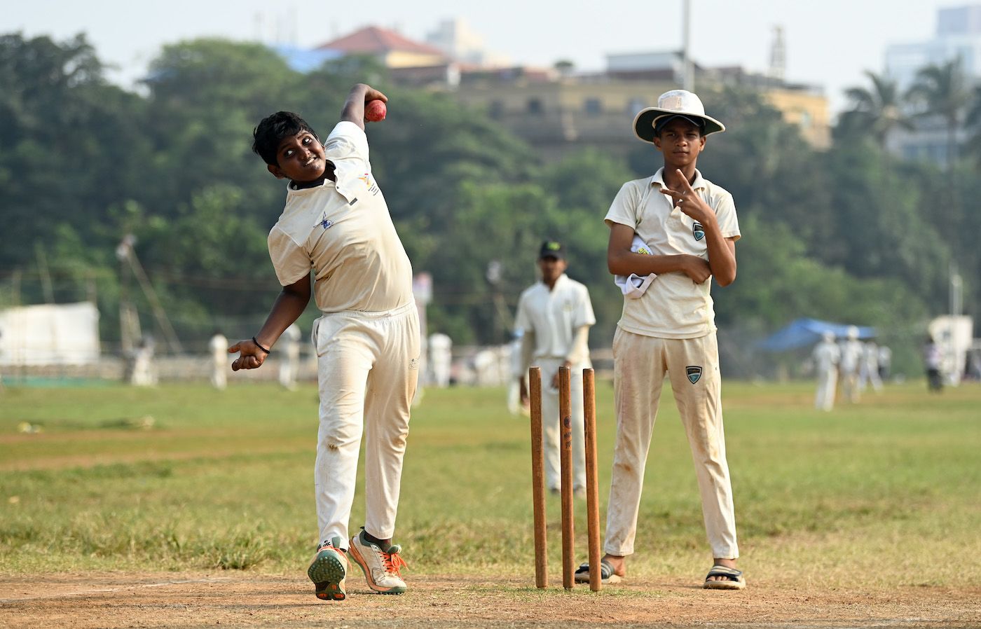 The umpire offers peace as a left-armer runs in at Mumbai's Azad Maidan ...