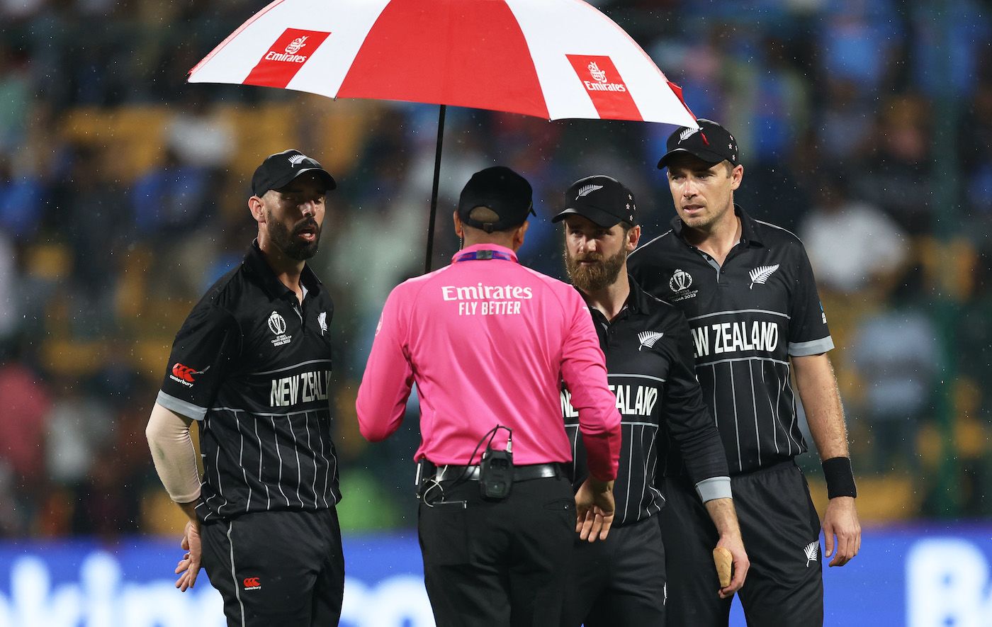Daryl Mitchell, Kane Williamson, and Tim Southee talk to an official at ...