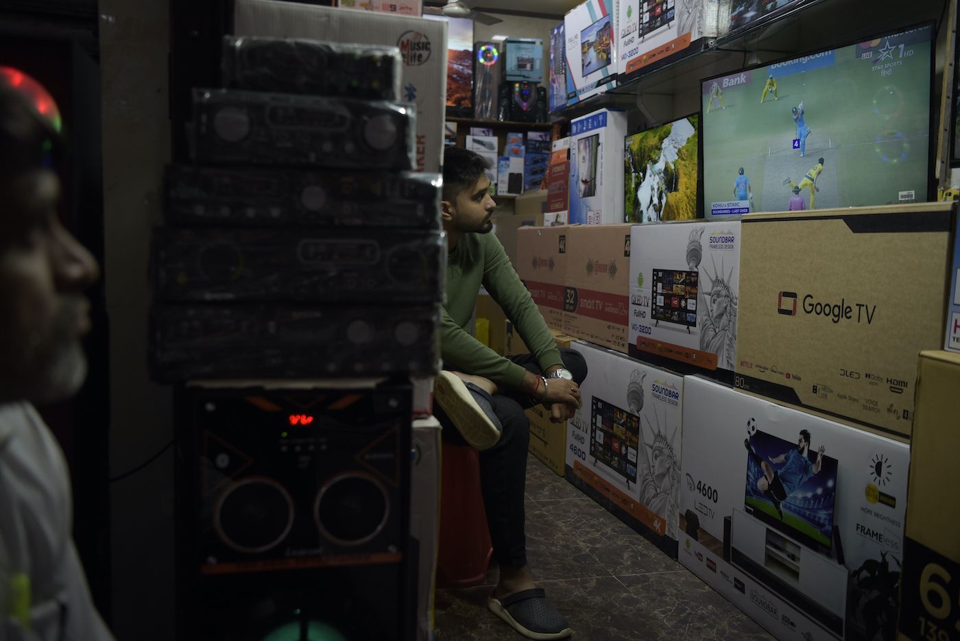 An electronics store in Old Delhi houses a spectator for the World Cup ...