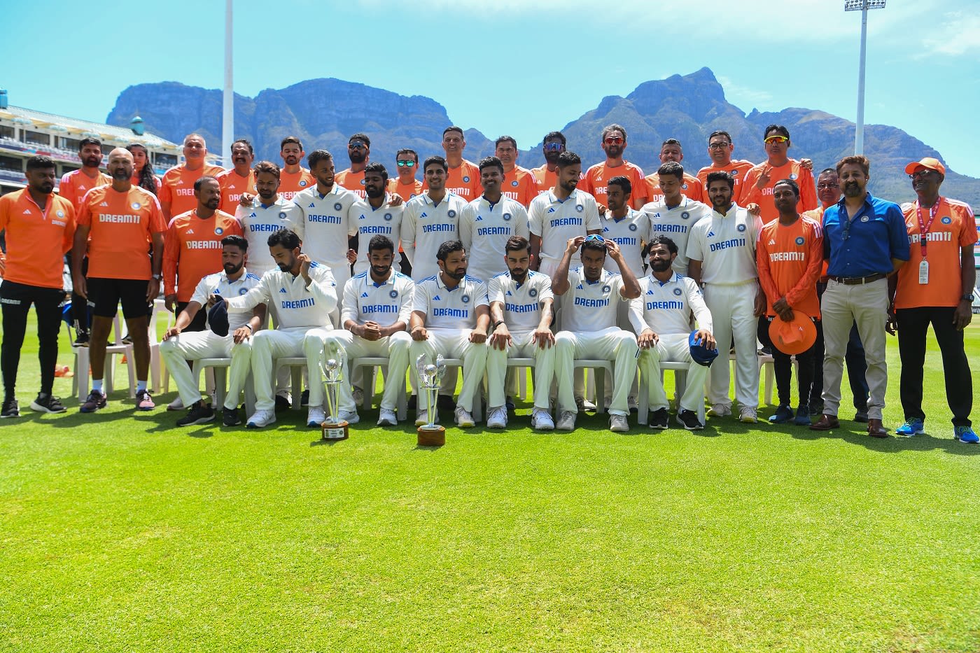 India's players and staff pose with the Table Mountain at the back ...