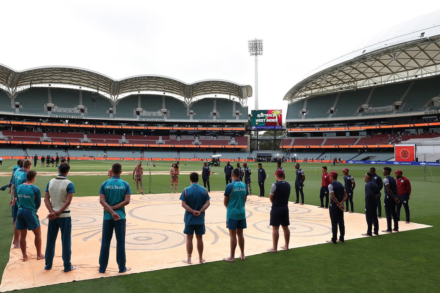Players take part in the bare foot circle ceremony ahead of the start ...