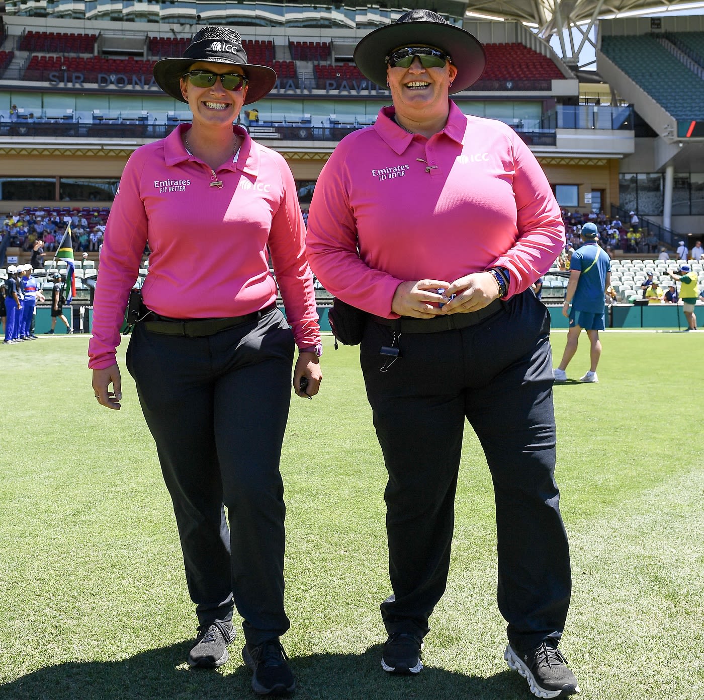 Umpires Claire Polosak and Sue Redfern are all smiles as they walk out ...