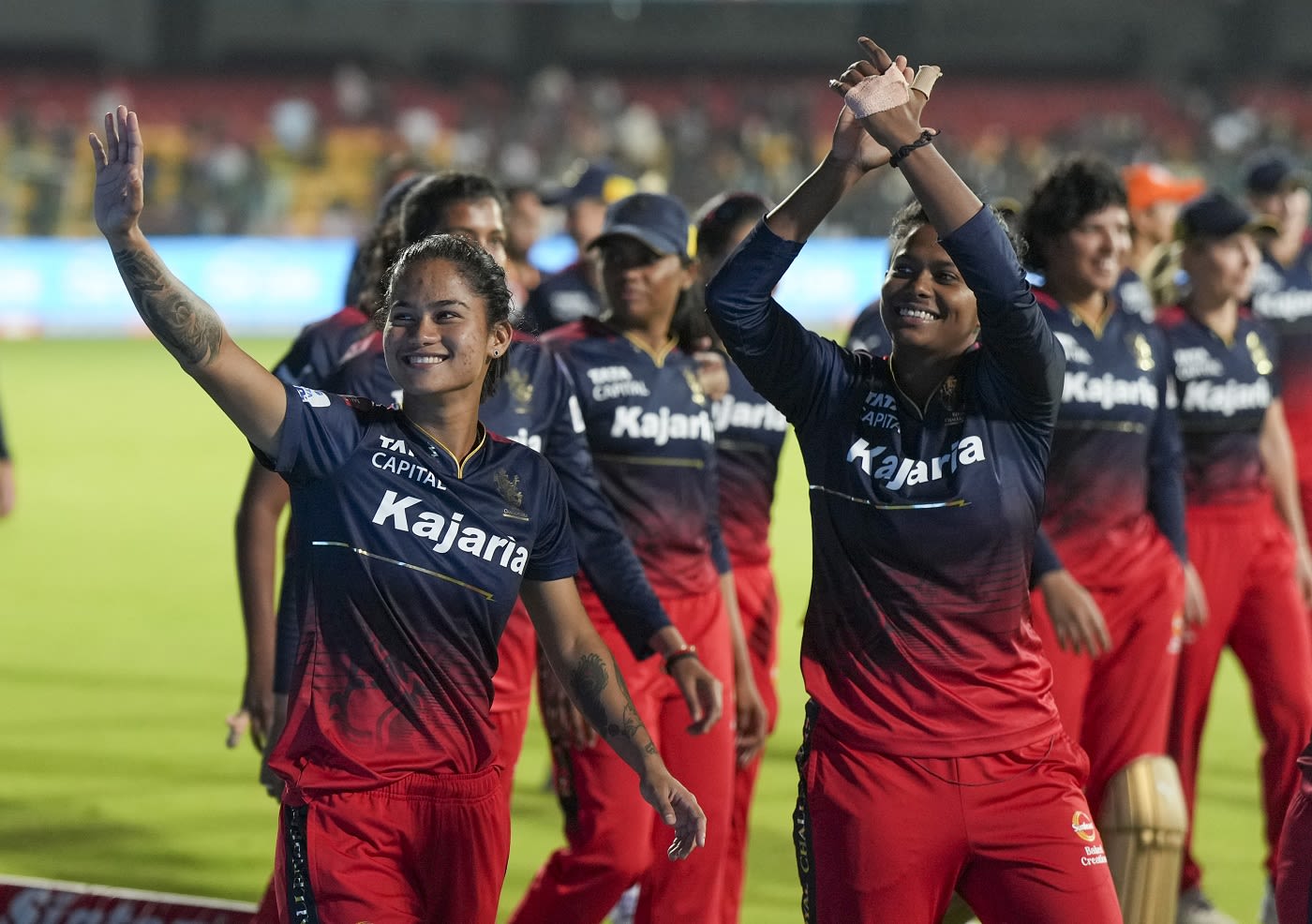 RCB players led by Simran Bahadur and Indrani Roy acknowledge the crowd ...