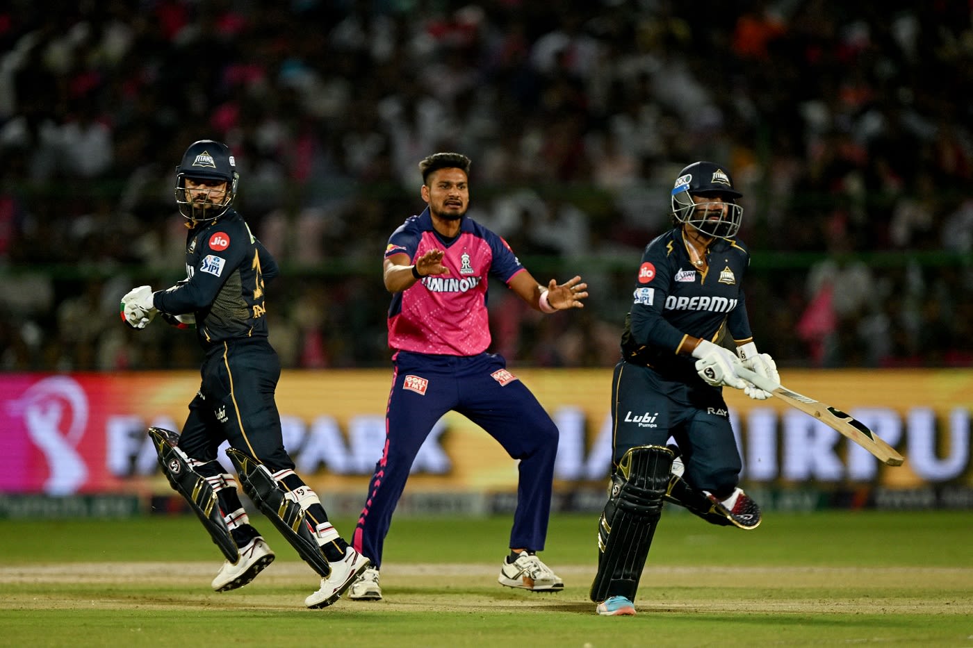 Rashid Khan and Rahul Tewatia run between the wickets as Kuldeep Sen ...
