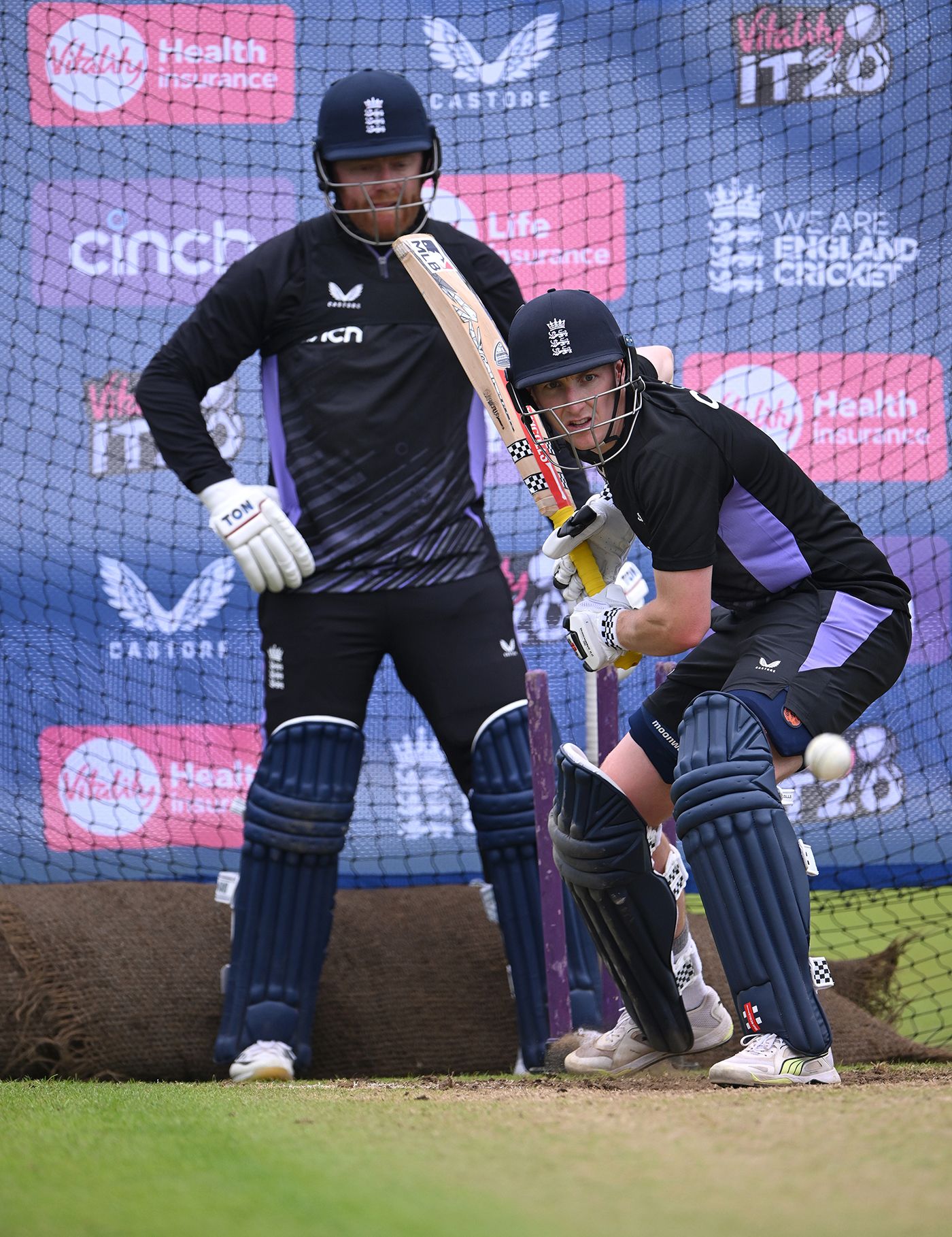 Harry Brook bats in the nets while Jonny Bairstow looks on ...