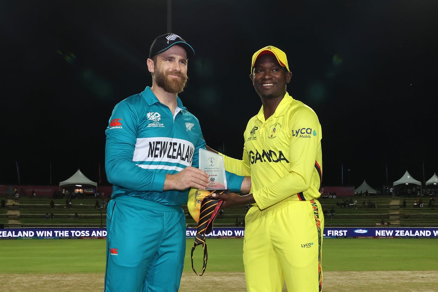 Kane Williamson is presented with a gift from Brian Masaba ...