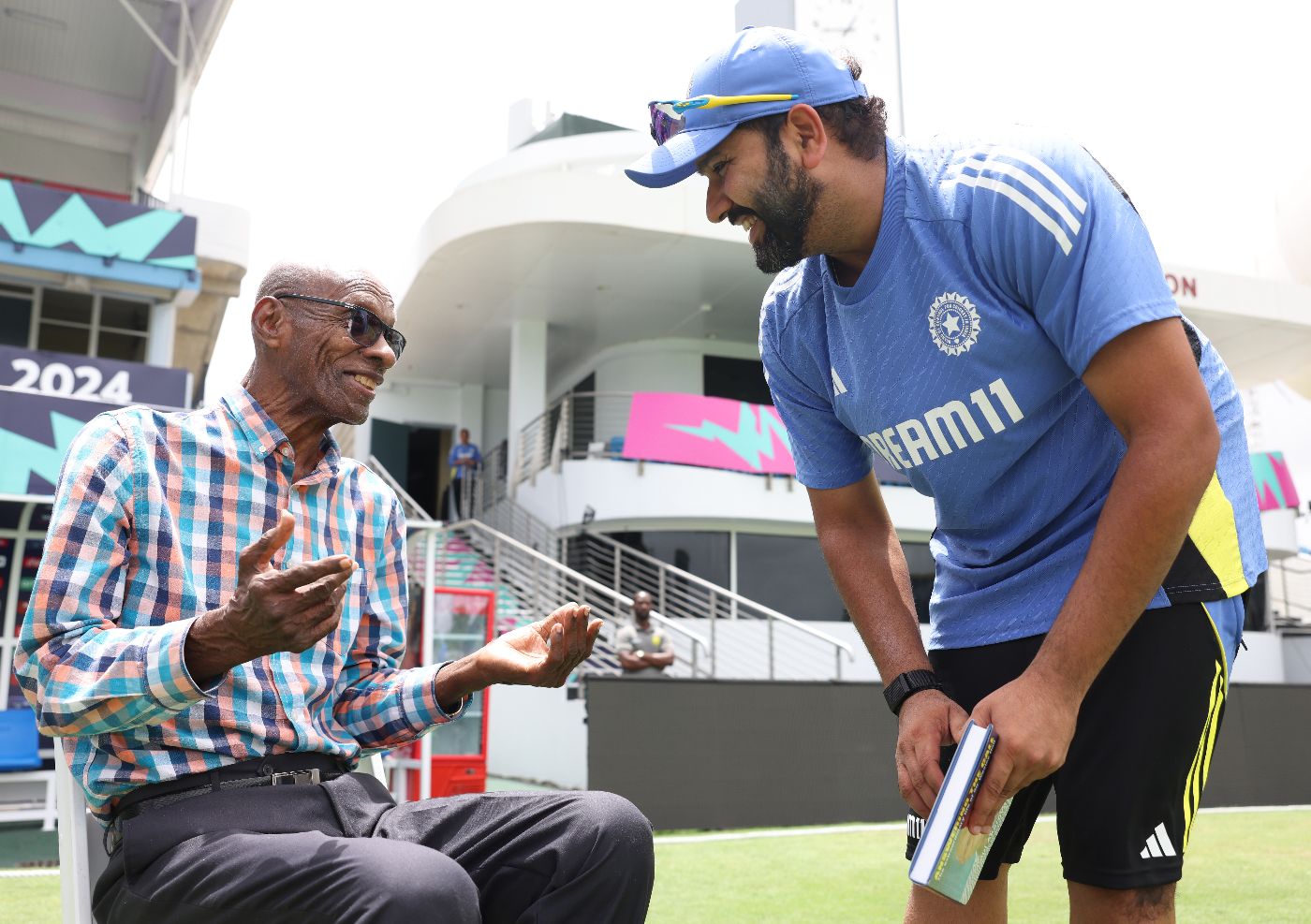 Wes Hall has a laugh with Rohit Sharma while presenting him with his ...