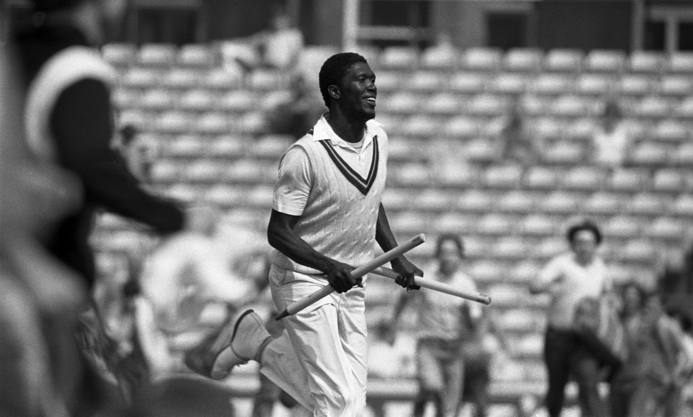 Joel Garner runs off the pitch with a stump in each hand after his four ...