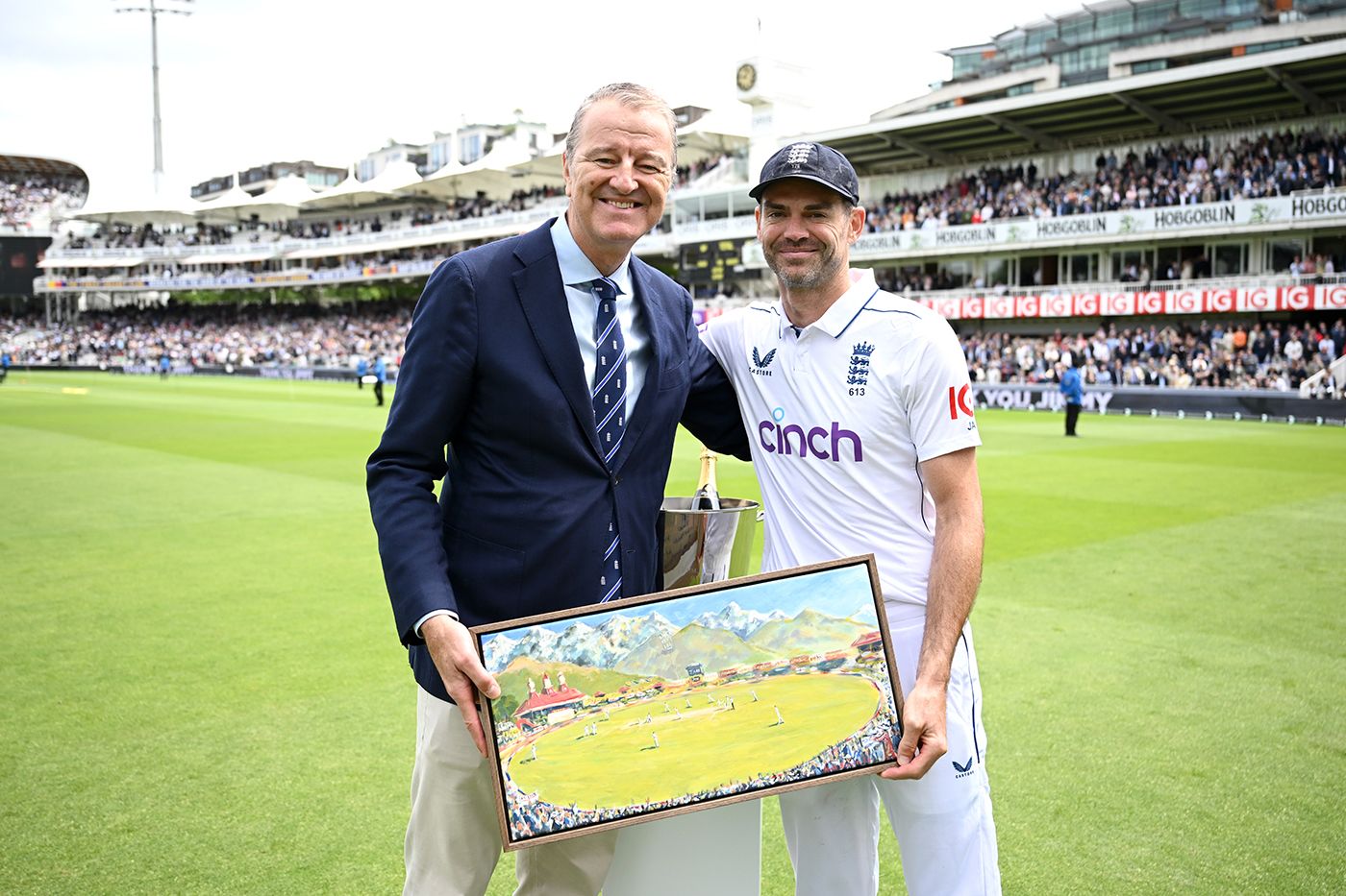 James Anderson is presented with a painting by ECB chair Richard ...