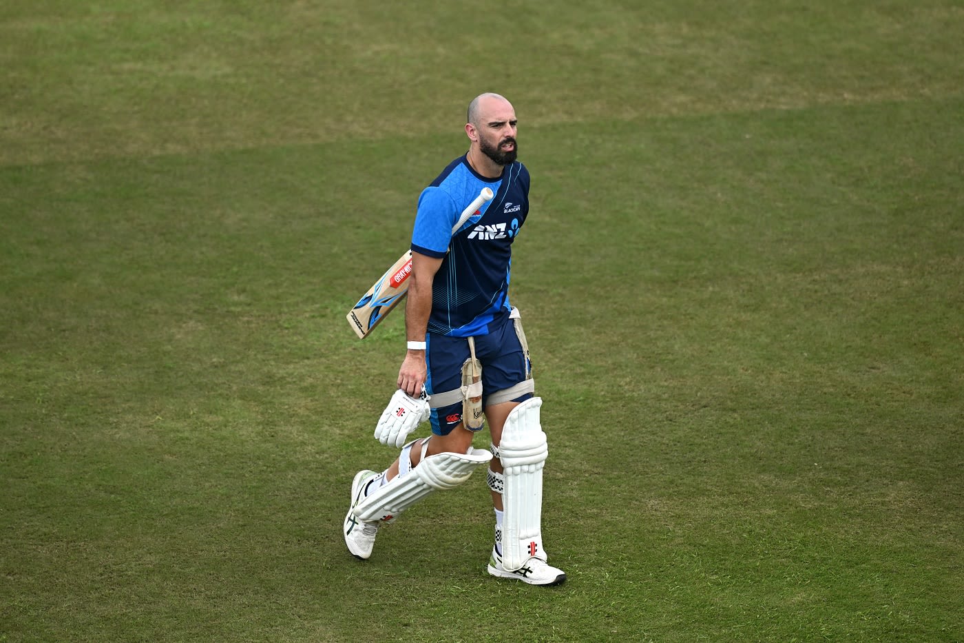 Daryl Mitchell walks back after a training session | ESPNcricinfo.com