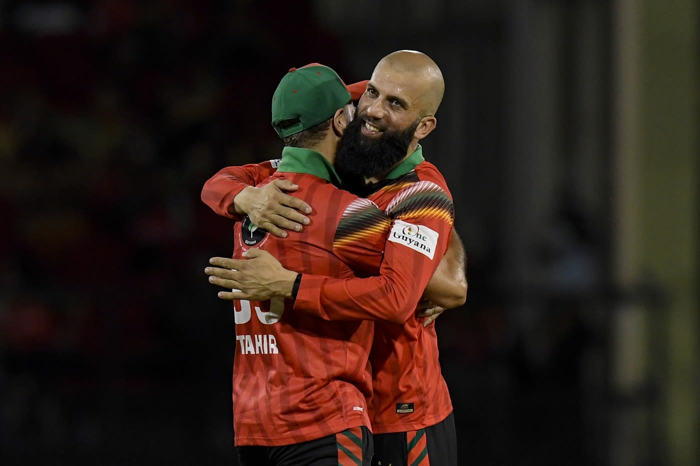 Moeen Ali gets a hug from Imran Tahir after taking a wicket ...