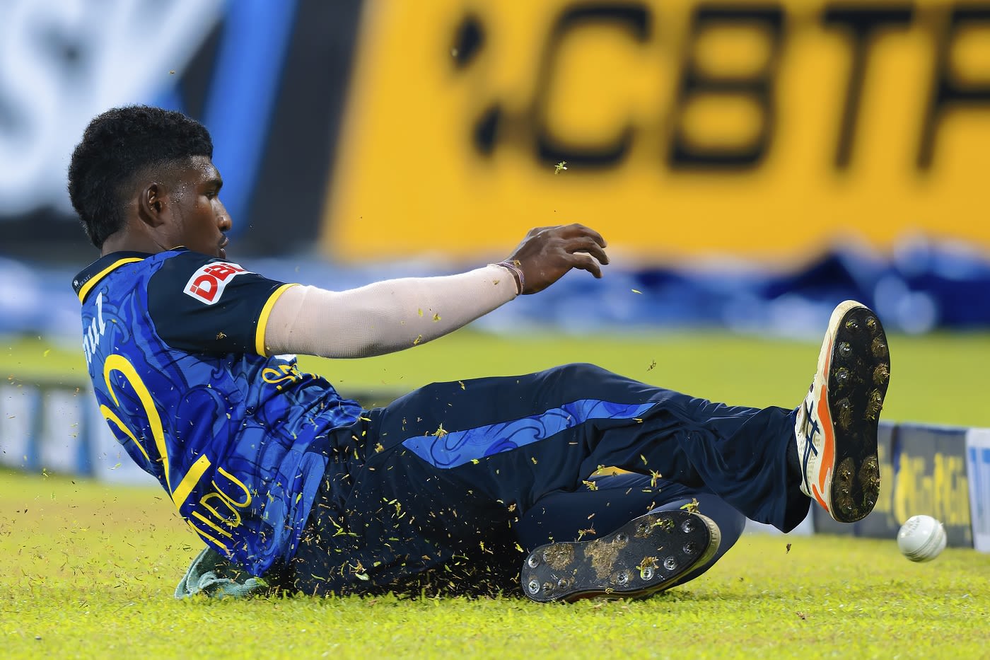 Chamindu Wickramasinghe slides across the field | ESPNcricinfo.com