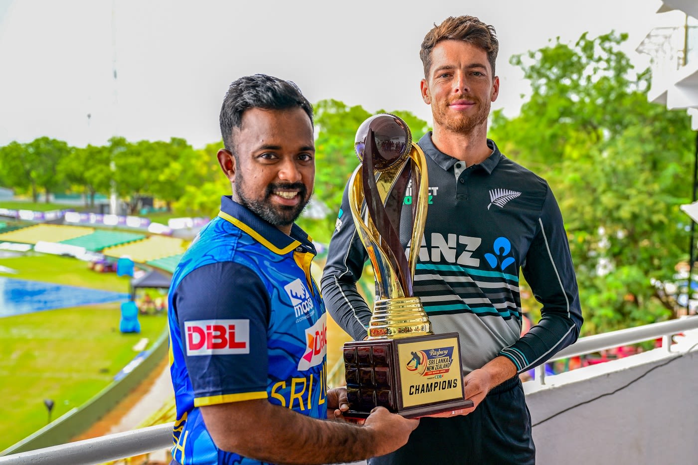 Charith Asalanka and Mitchell Santner pose with the T20 trophy | ESPNcricinfo.com