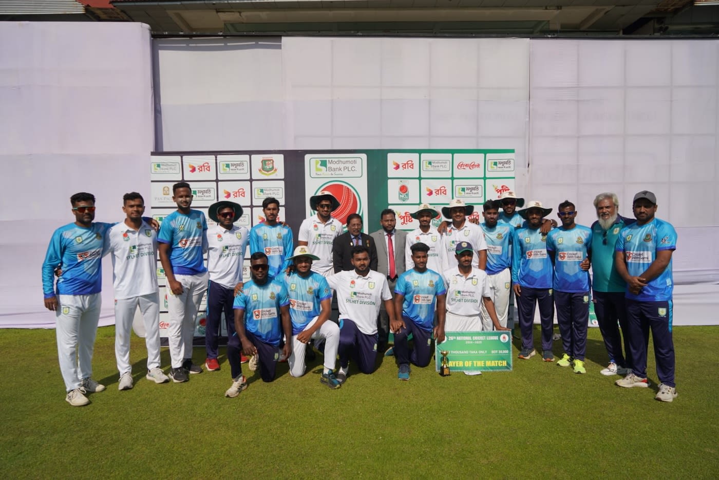 The Sylhet Division players pose after their victory over Barishal ...