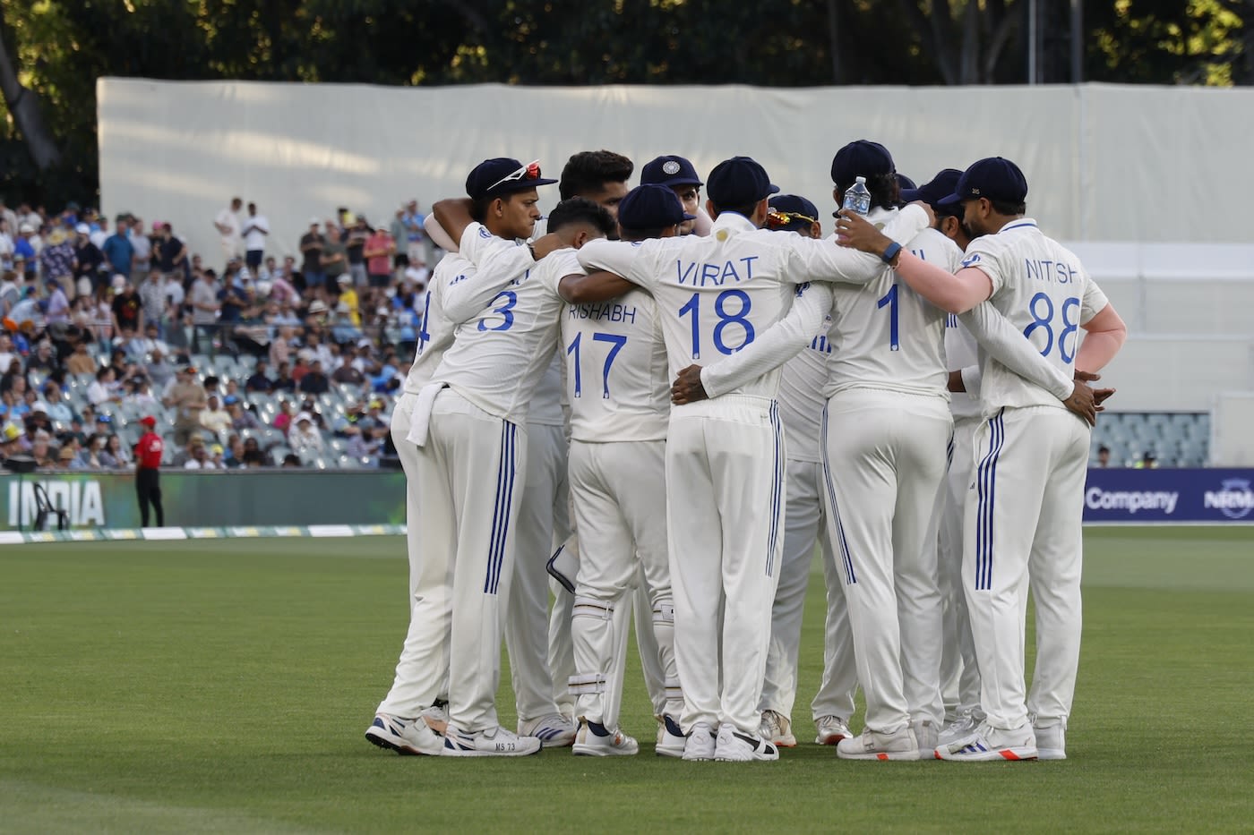 The Indian team gets into a huddle before Australia's innings ...