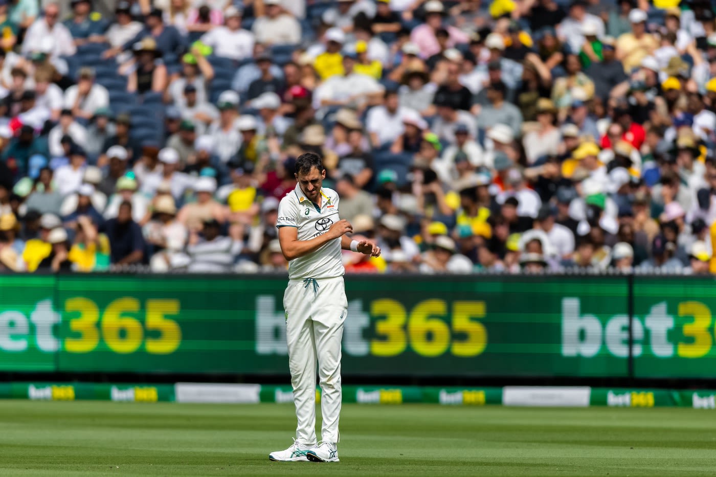 Mitchell Starc was often spotted stretching his back at the MCG ...