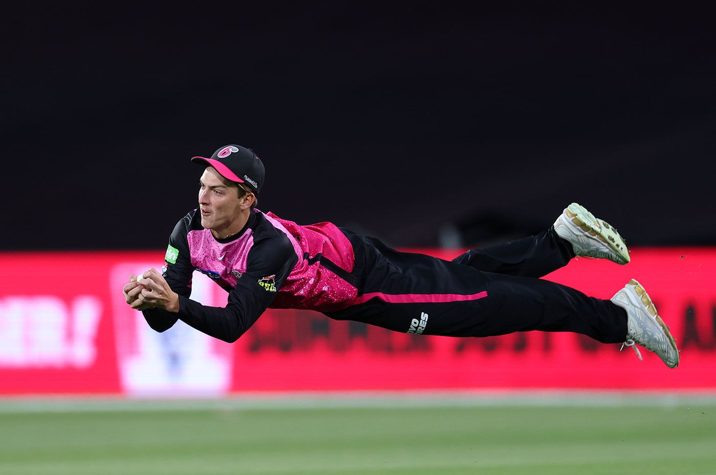 Lachlan Shaw goes airborne to claimed a fantastic outfield catch ...
