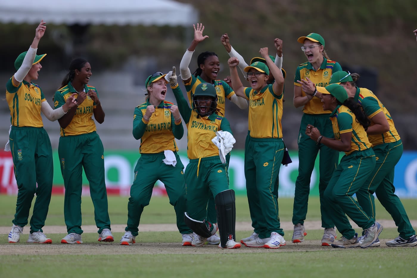 South Africa, led by Seshnie Naidu and wicketkeeper Karabo Meso, celebrate a Nigerian wicket ...