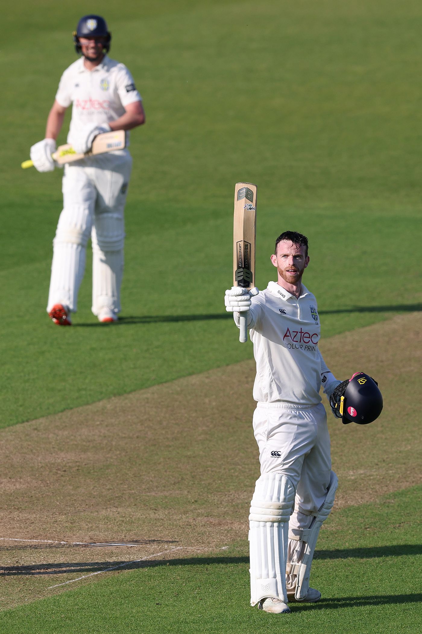 Graham Clark raises his bat on reaching a century | ESPNcricinfo.com