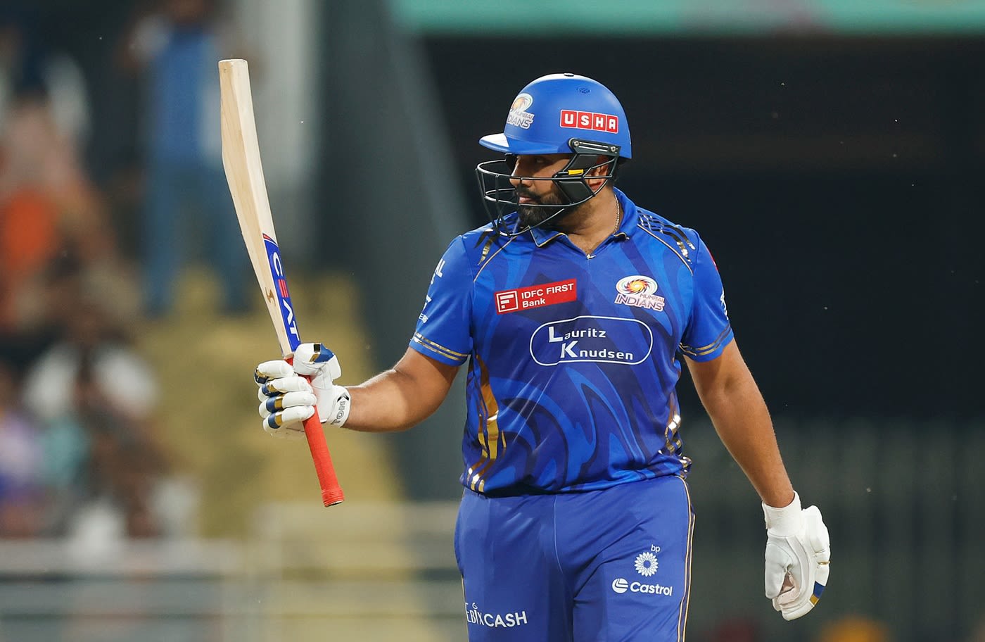 Rohit Sharma raises his bat after getting to a half-century | ESPNcricinfo.com
