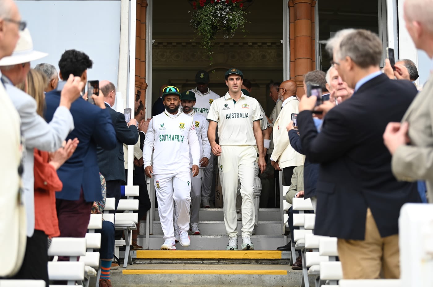 Temba Bavuma and Pat Cummins, the two captains, walk out with their ...