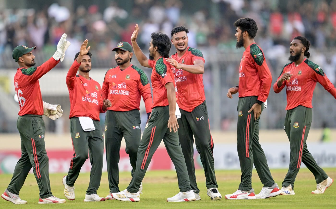 Tanzim Hasan Shakib celebrates a wicket with his team-mates ...