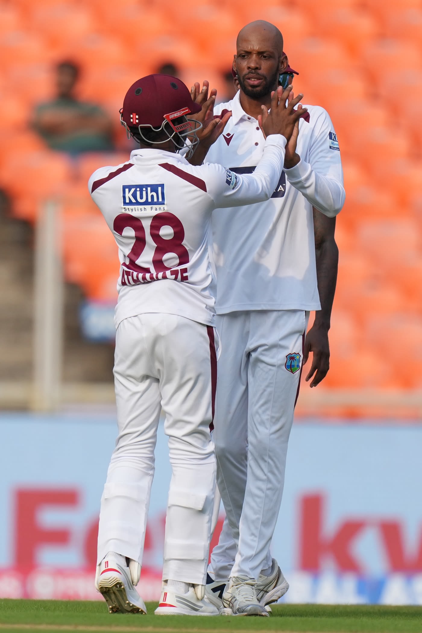 Captain Roston Chase and Alick Athanaze celebrate a wicket ...