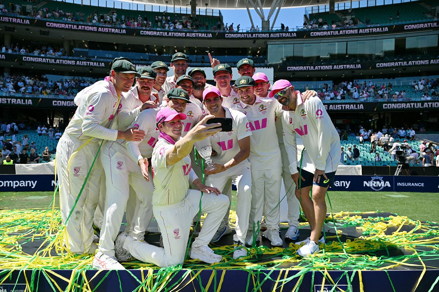 Australia pose with the Ashes trophy after sealing a 4-1 series win ...