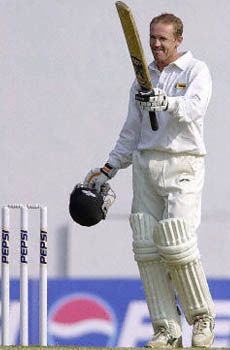 Andy Flower acknowledges the crowd as he reaches his century ...